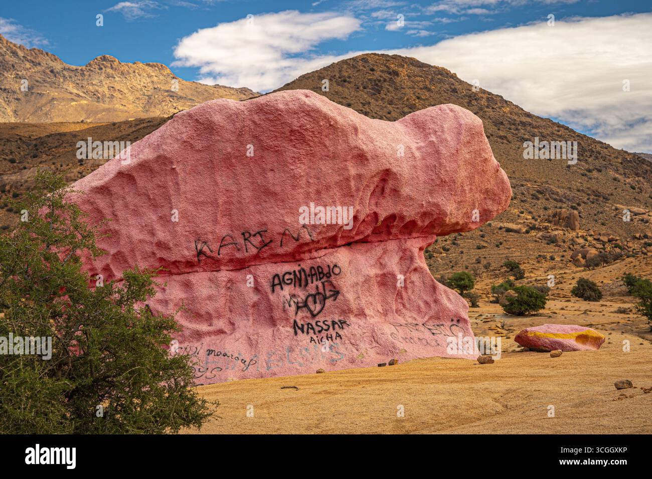 Pink painted rock with graffiti in Tafraout Morocco, part of the ...
