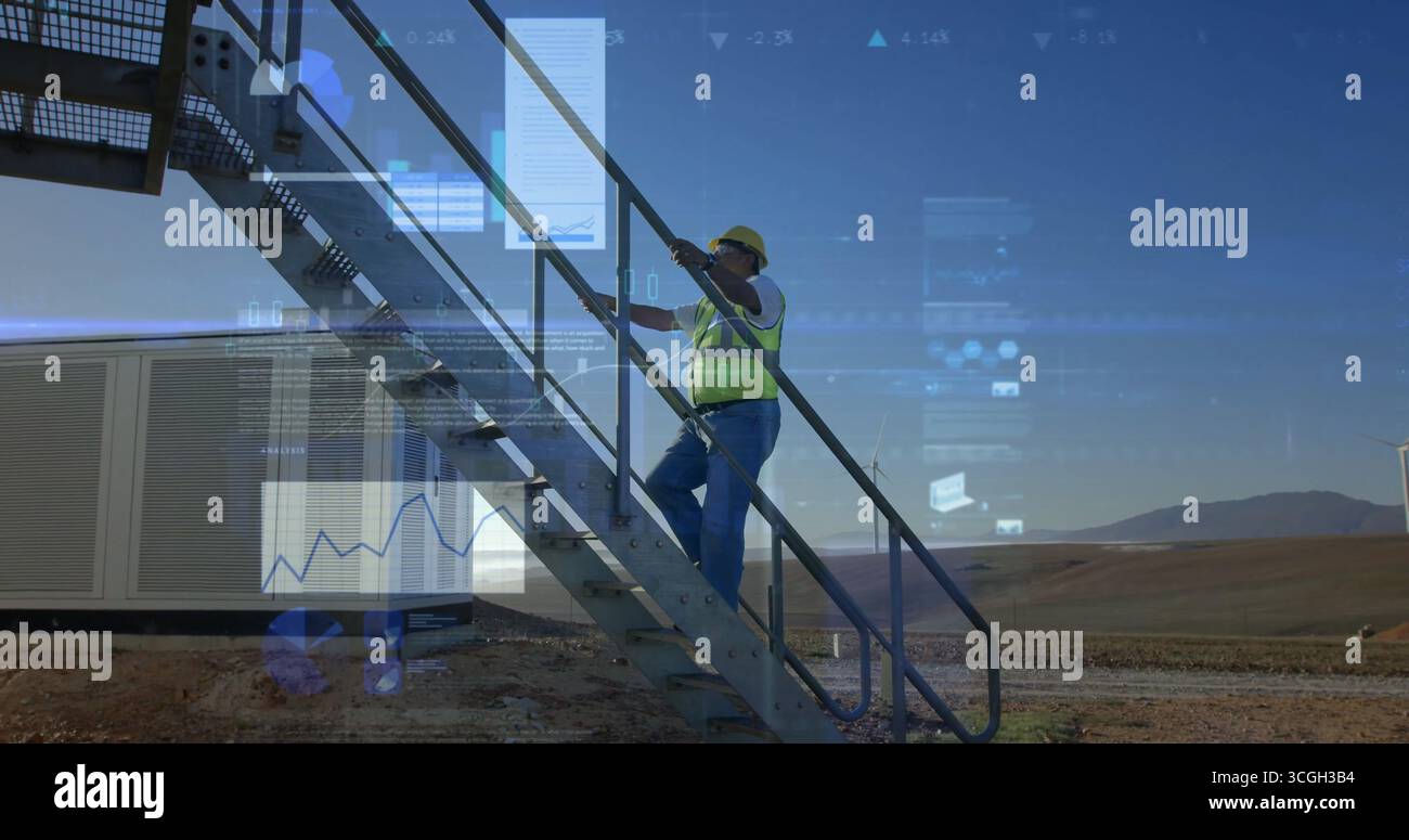 Climbing engineer wearing hard hat and vest ascending staircase at wind ...