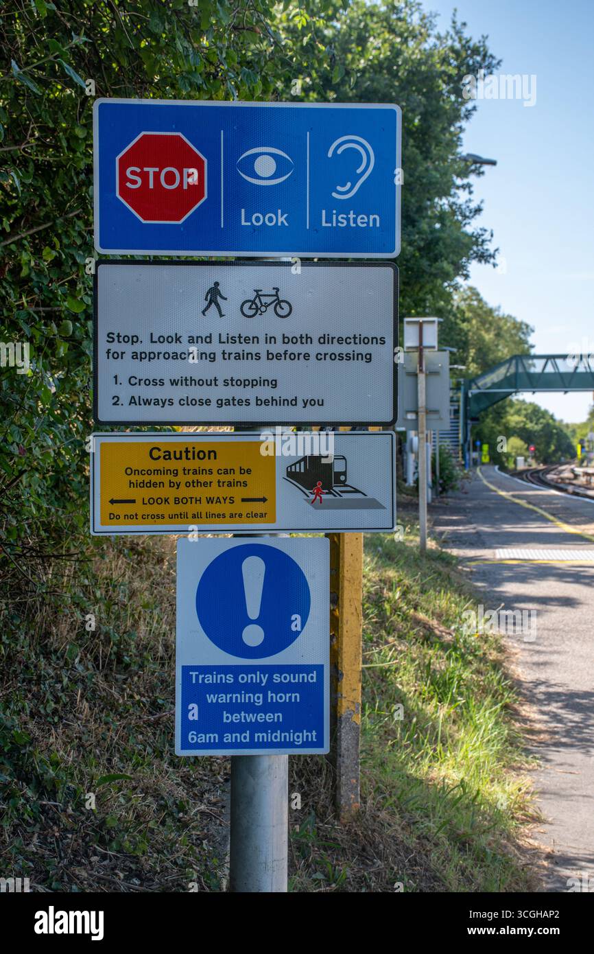 Safety and warning signs by the footpath over the railway tracks at ...
