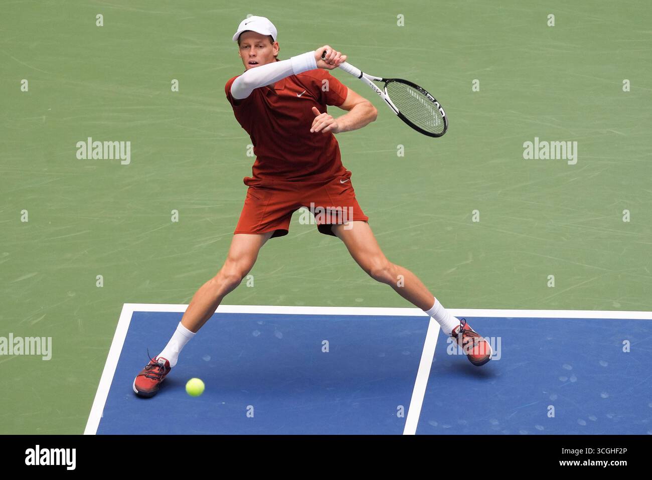 Jannik Sinner, of Italy, returns a shot to Alexei Popyrin, of Australia ...