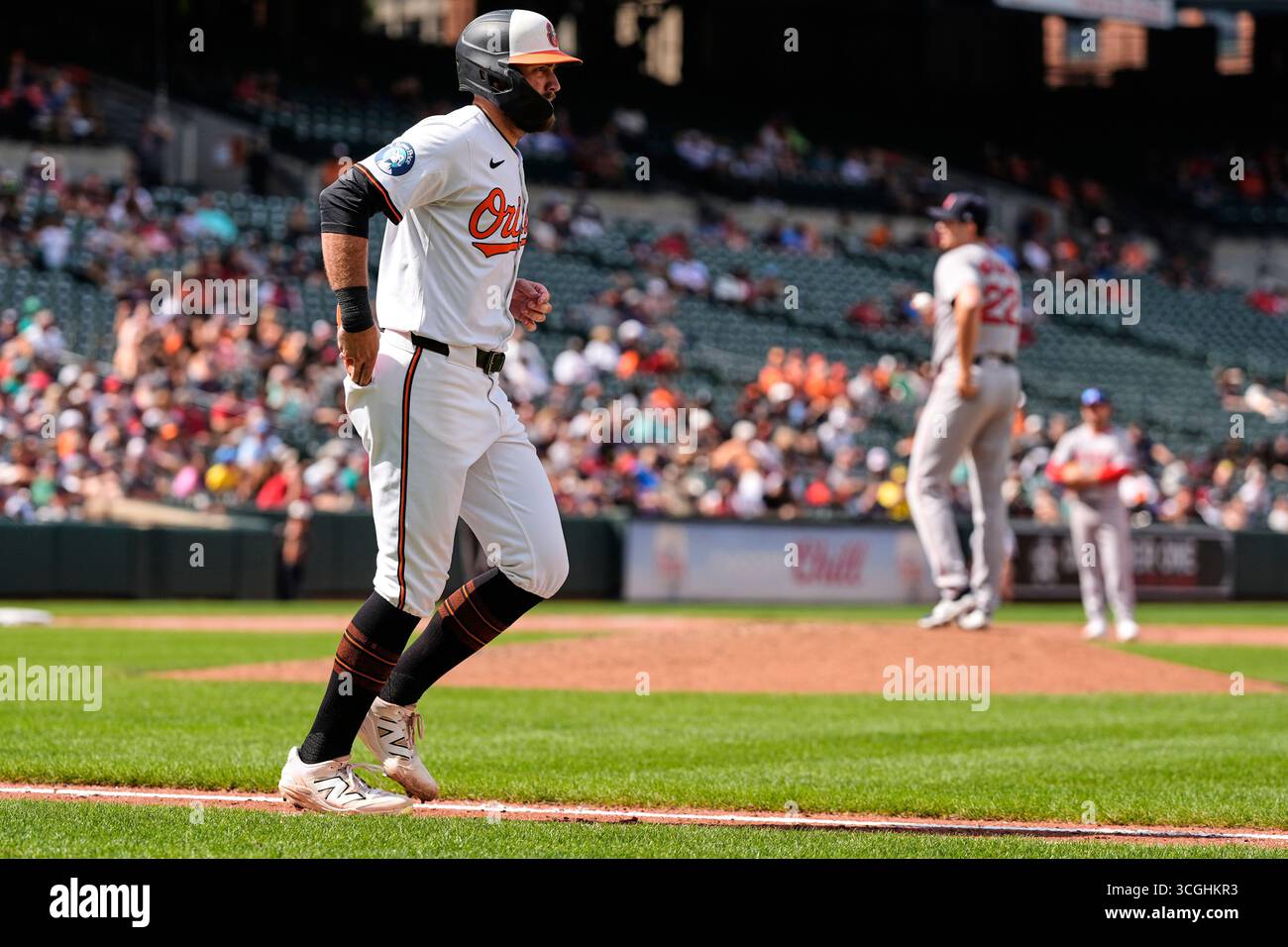 Baltimore Orioles' Colton Cowser, left, is walked by Boston Red Sox ...