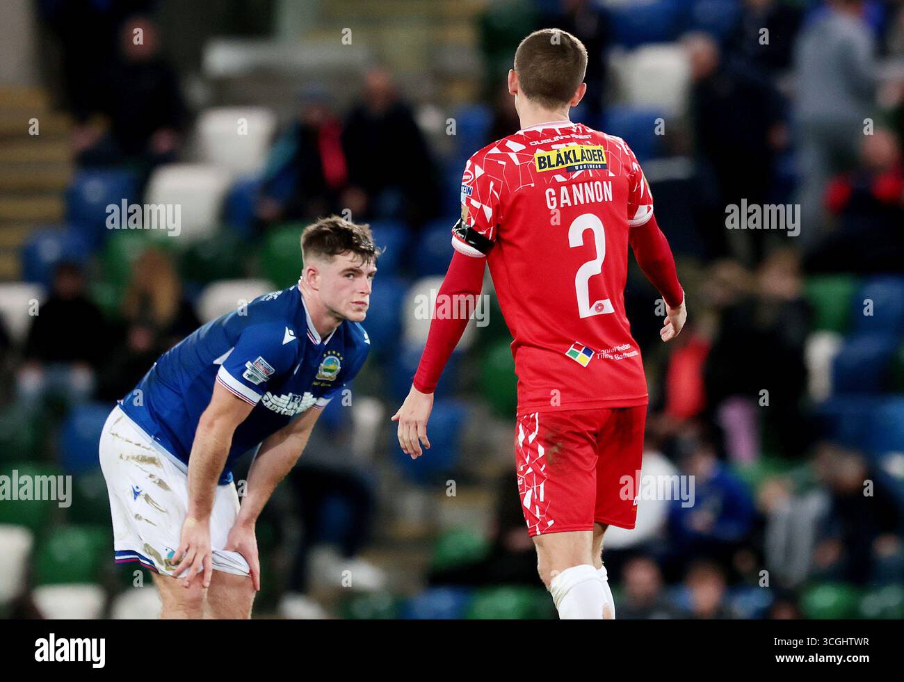 Shelbourne's Sean Gannon (right) goes to console Linfield's Kieran ...
