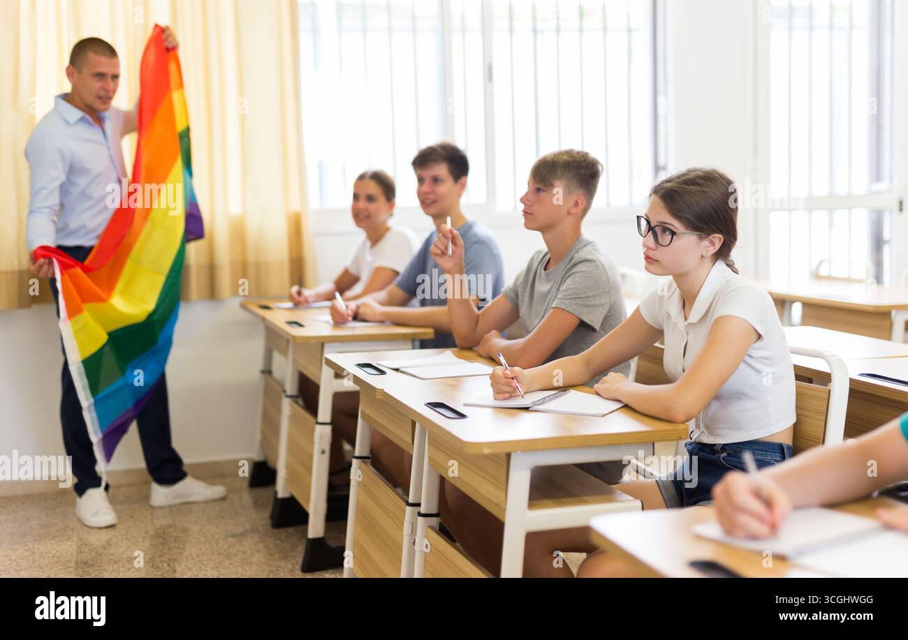 Pupils in classroom listen to teacher who explains what is LGBT Stock ...