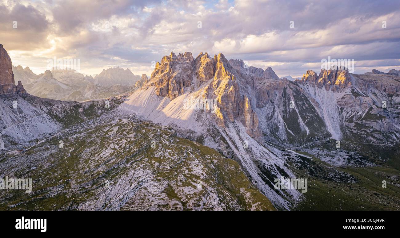 Dramatic peaks in the Dolomites Italy glowing in evening sunlight with ...