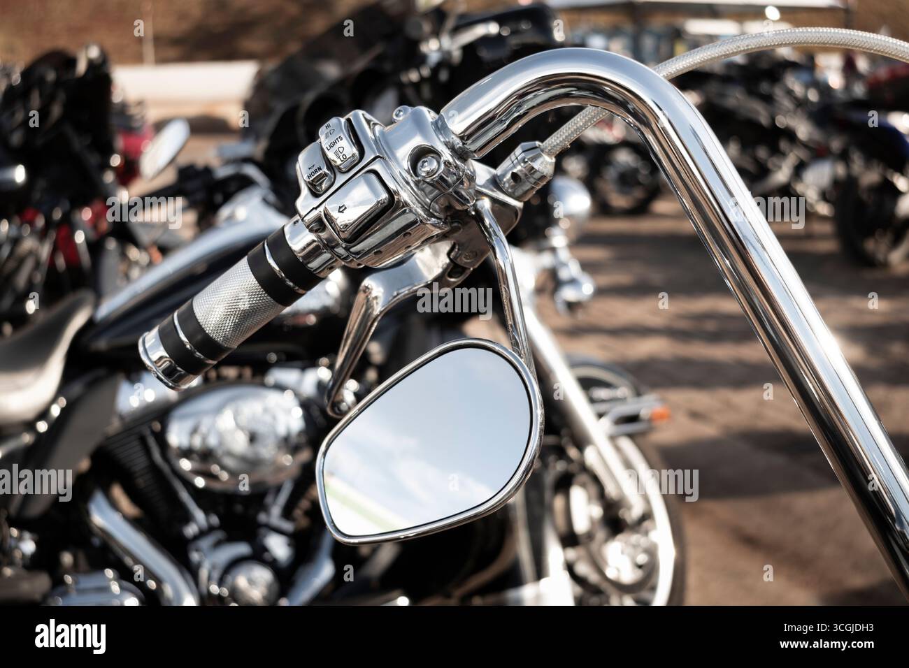 Detail of the chrome handlebar of a motorcycle with lever, electrical ...