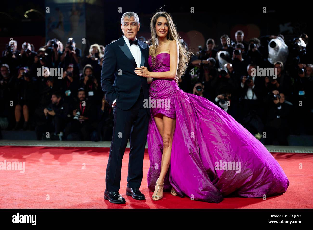 George Clooney, left, and Amal Clooney pose for photographers at the ...