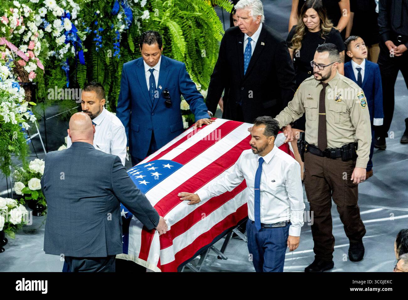 The casket of Tremonton-Garland police officer Eric Estrada is brought ...