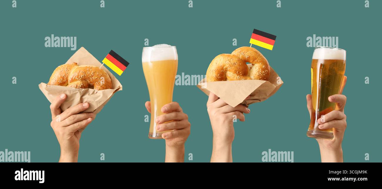 Hands with beer, German flags and pretzels on green background ...