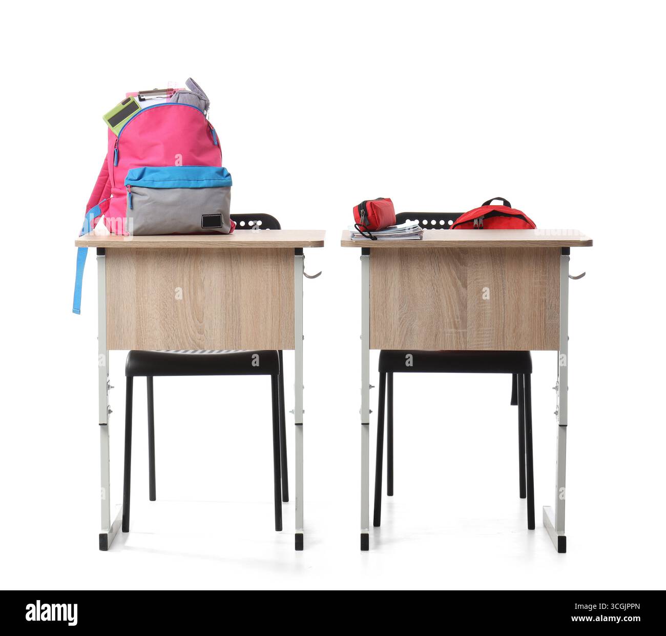 School desks with backpacks on white background Stock Photo - Alamy