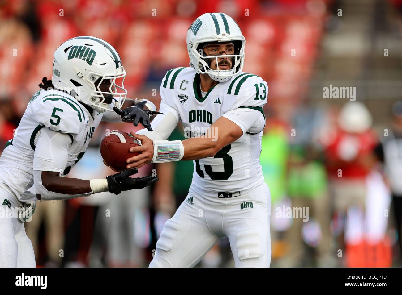 Ohio QB Parker Navarro (13) hands off to Sieh Bangura (5) against ...