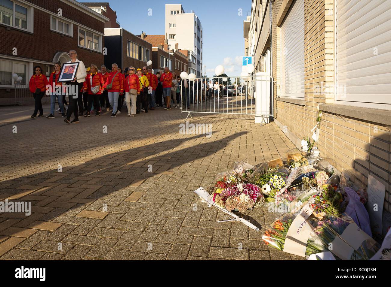 People attend a silent vigil for Herwin Alleman (56) who was beaten to ...