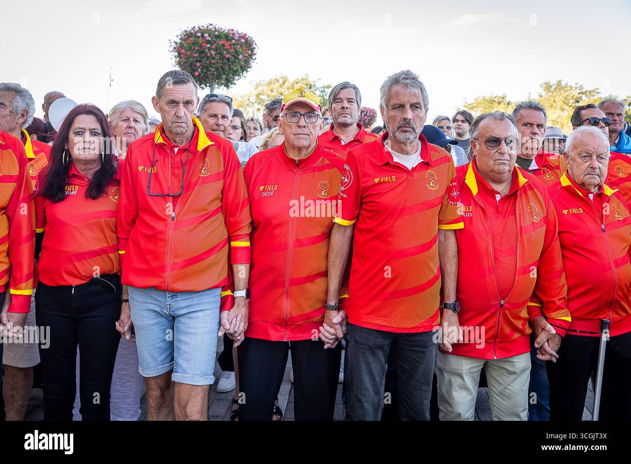 People attend a silent vigil for Herwin Alleman (56) who was beaten to ...