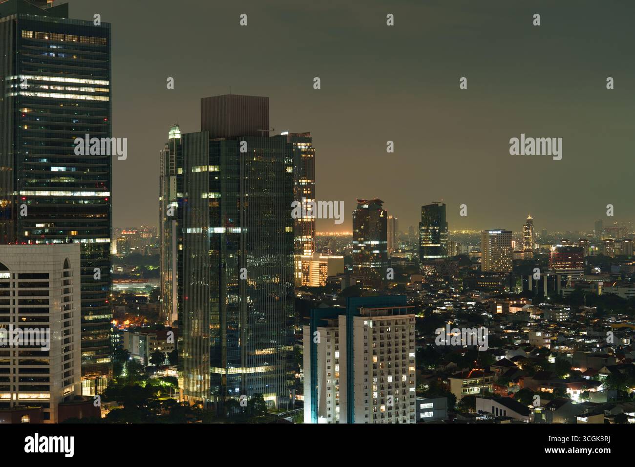 Jakarta skyline at night with illuminated office towers and city lights ...