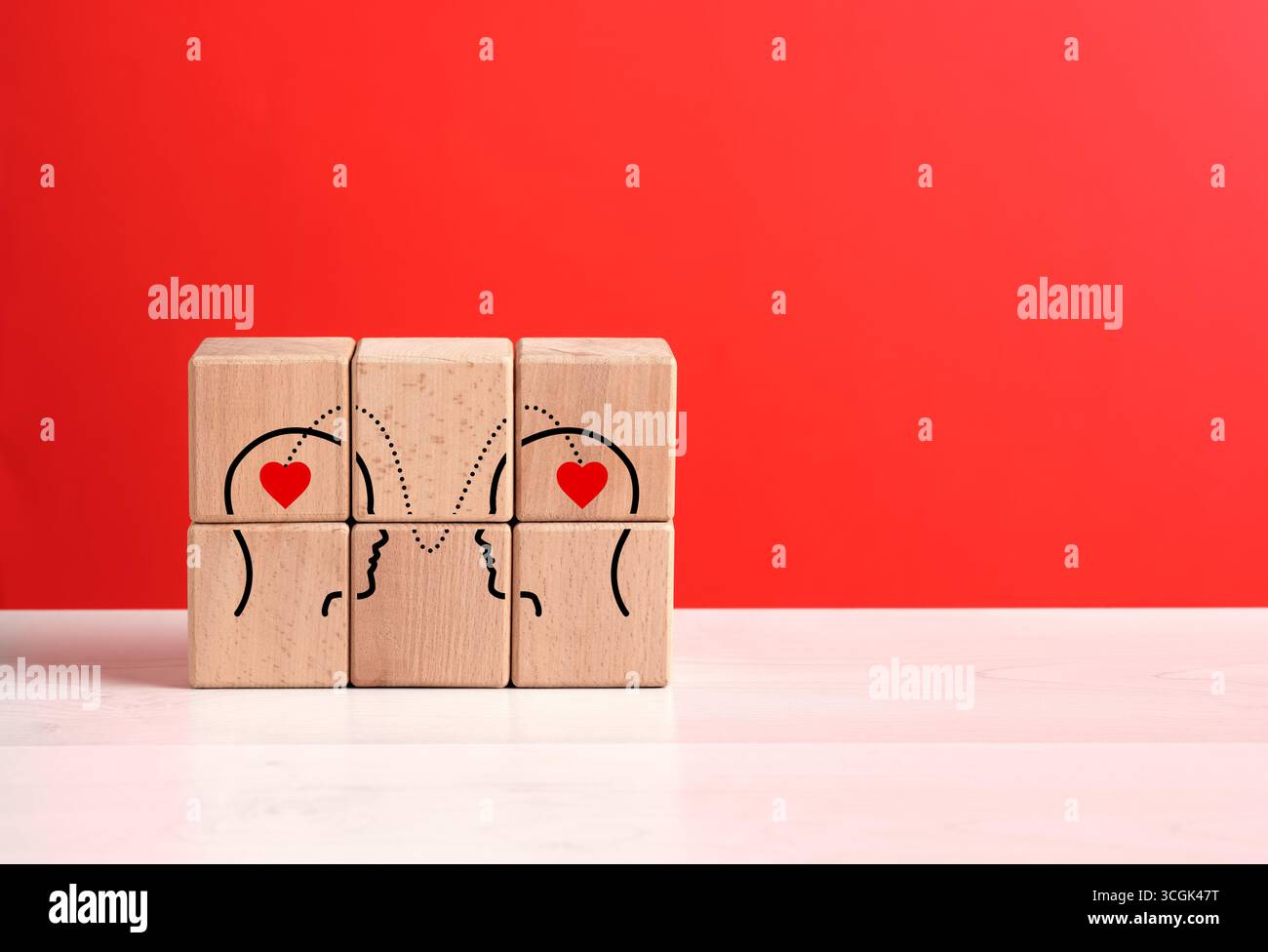 Wooden cubes showing two people communicating with empathy on red ...