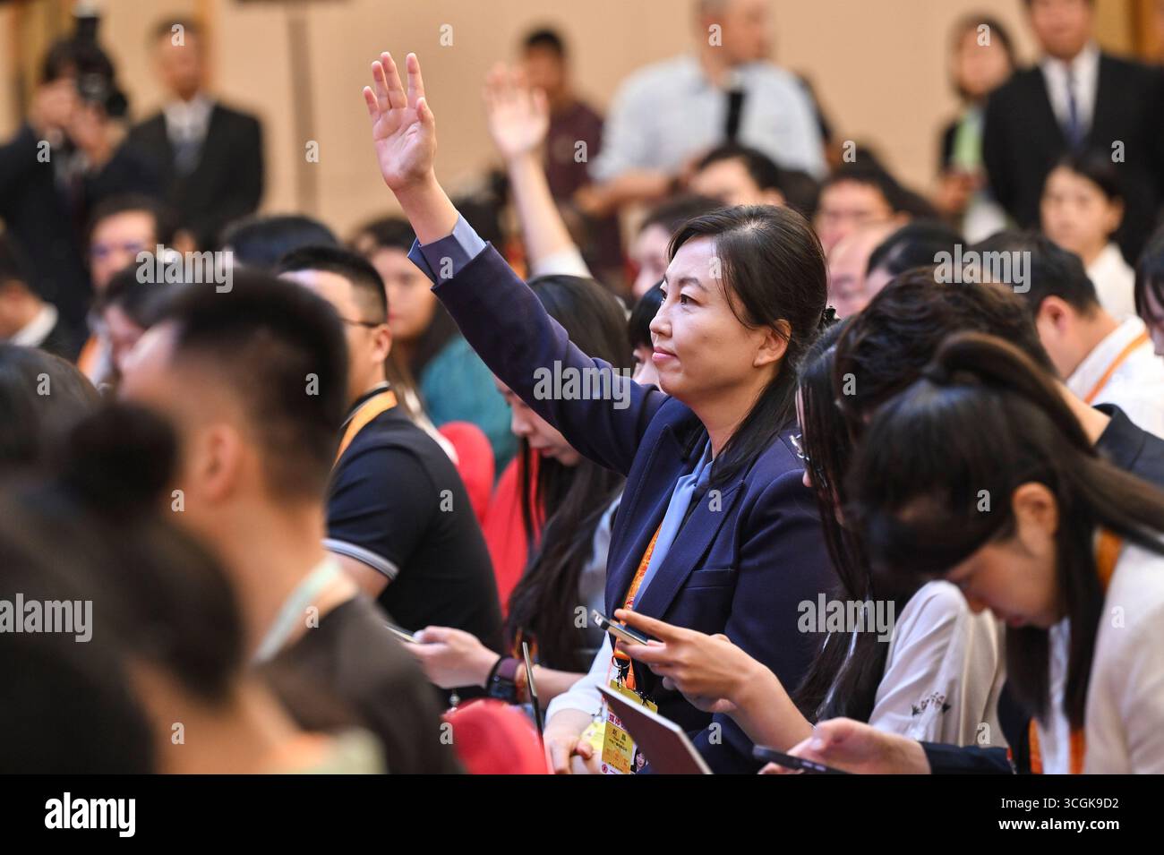 Beijing, China. 29th Aug, 2025. A journalist raises her hand to ask ...