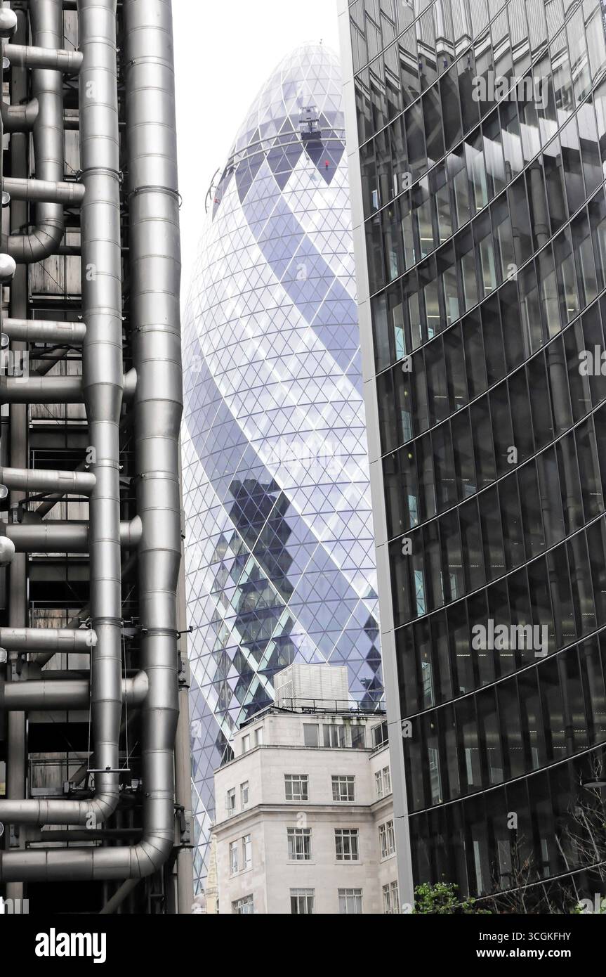 The Gherkin and neighbouring modern buildings with glass facades and ...