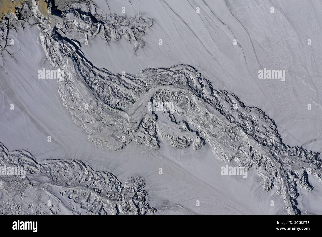 Aerial view of gray abstract mud patterns and cracks on acid mine ...