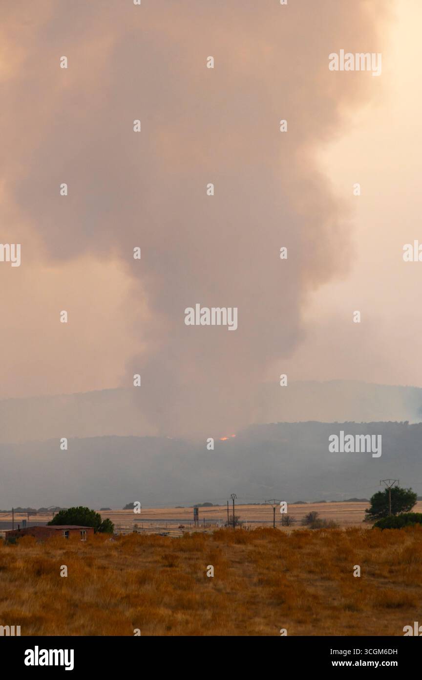 A Massive Plume of Smoke Rising from a Wildfire in Distant Hills Stock ...