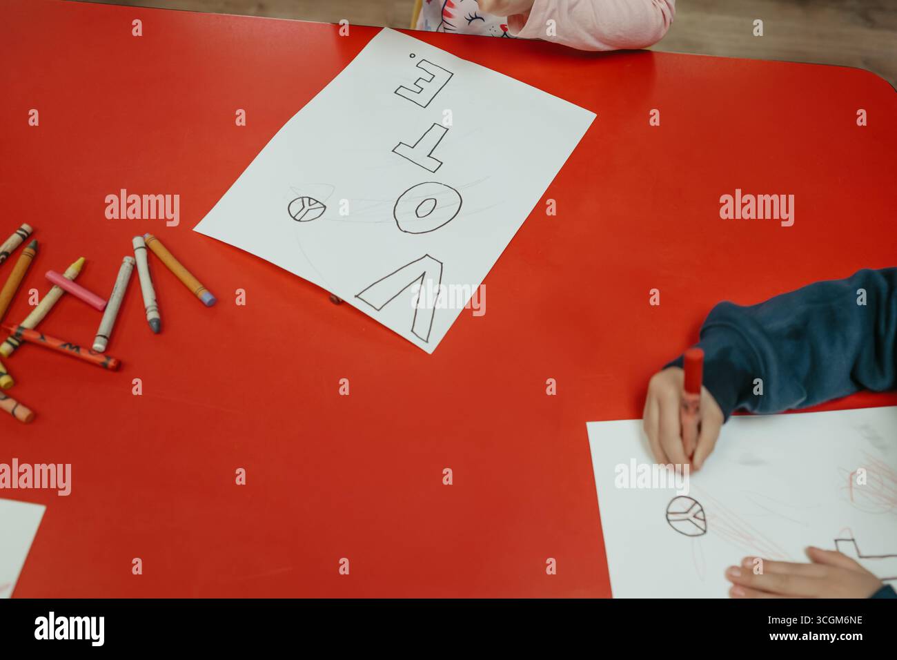 Preschoolers color peace symbols and the word vote at school Stock ...