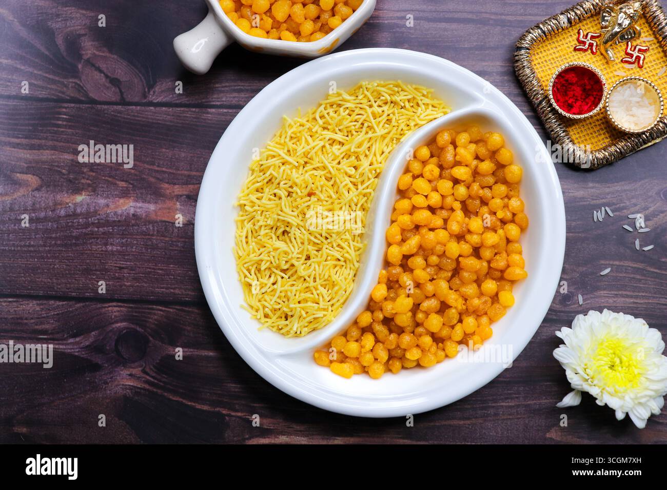 A close up of traditional Indian snacks. crispy savory sev and sweet ...