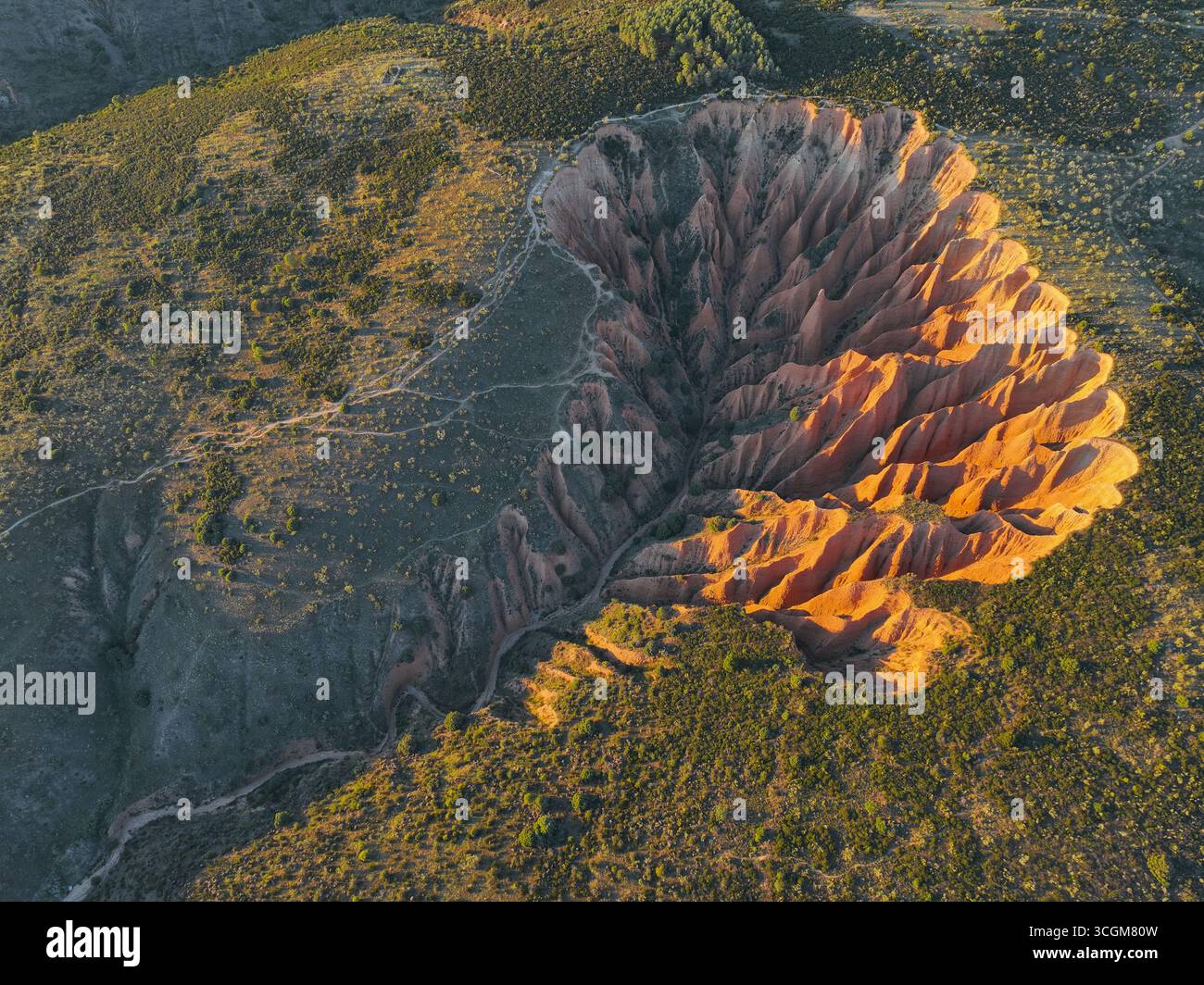Aerial view of the striking, sun-kissed badlands contrasting with the ...