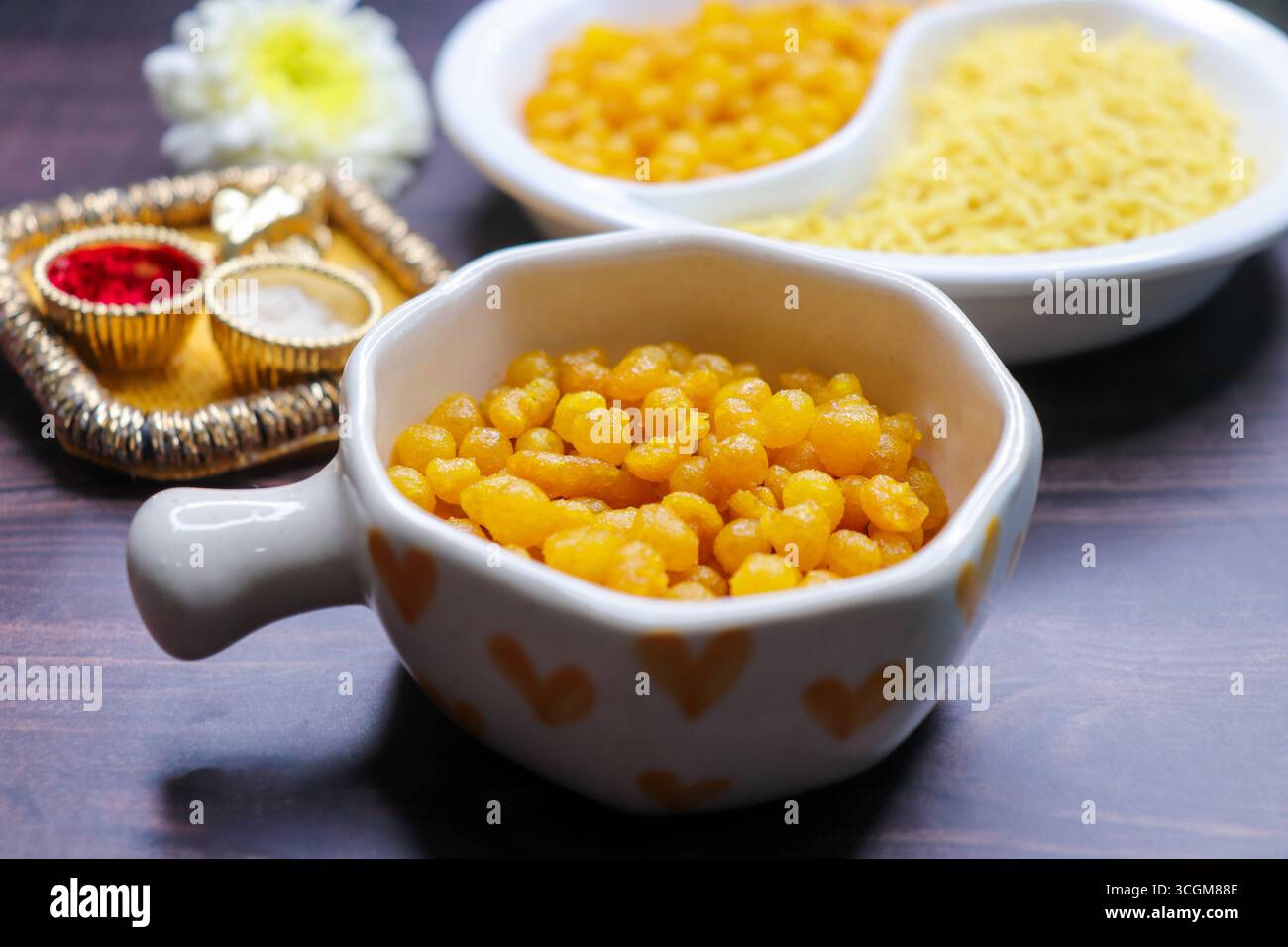 A close up of traditional Indian snacks. crispy savory sev and sweet ...