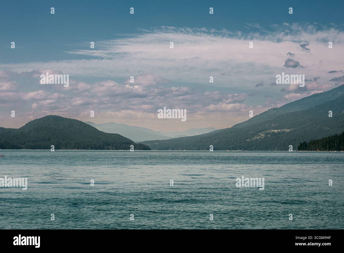 Expansive Lake with Mountain Range and Cloudy Sky Stock Photo - Alamy