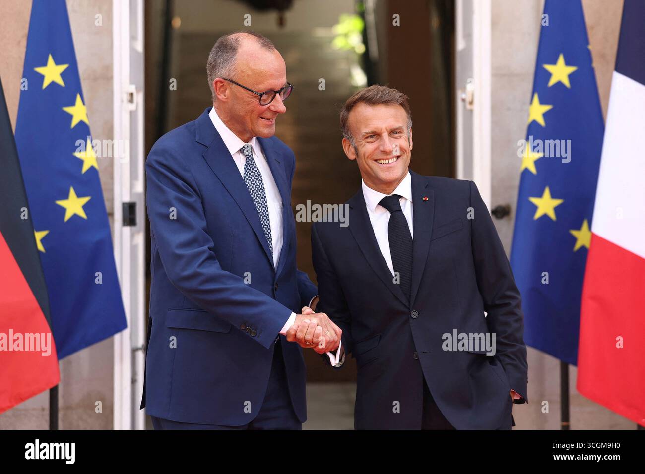 French President Emmanuel Macron, right, shakes hands with German ...