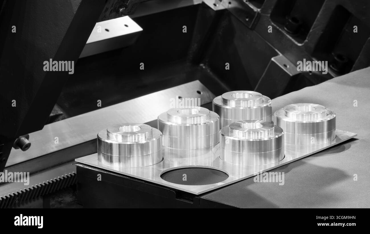 Row of metal cylinders are lined up in a row. The cylinders are all the ...