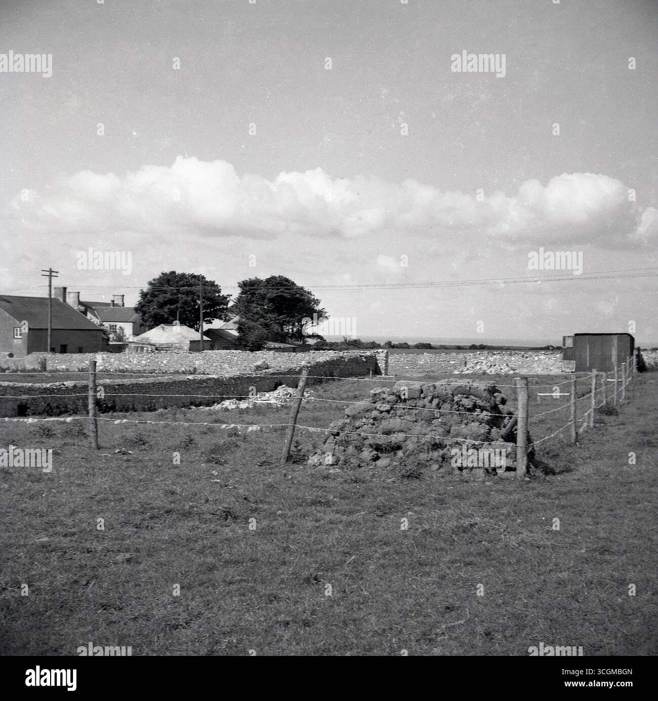 1950s, historical, a plot of farm land marked off for a new building. A ...
