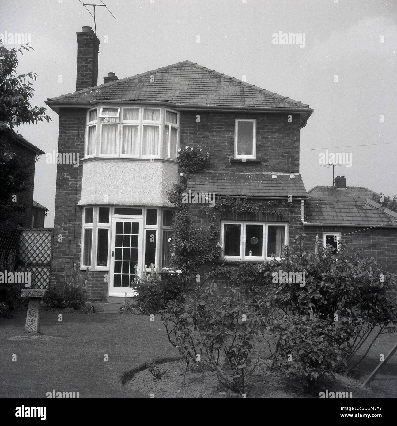 1960s, historical, rear view, from back garden of a two-storey detached ...