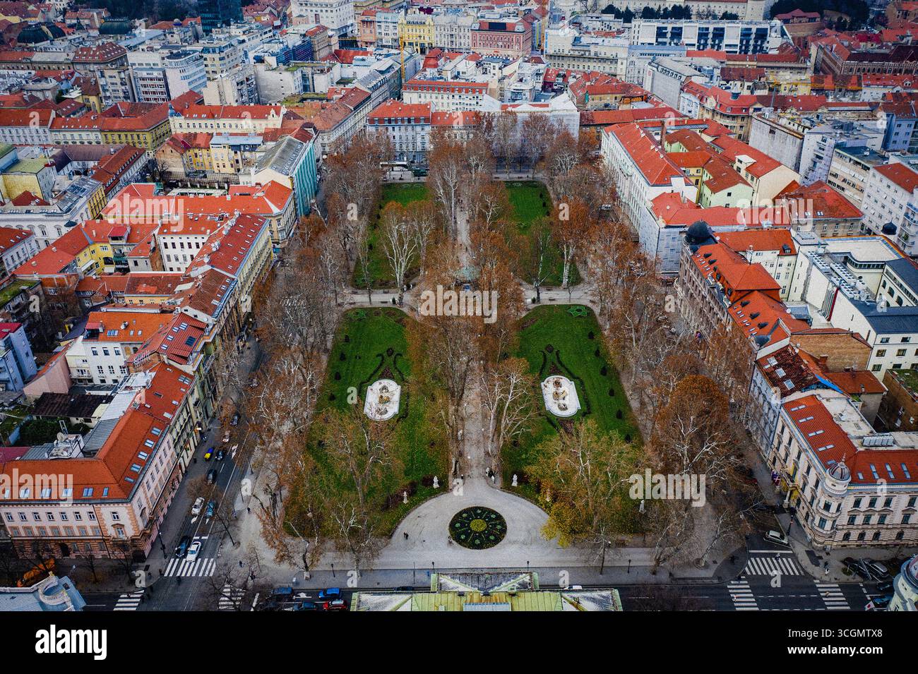 Aerial view of the vibrant green parks contrasting with the red-tiled ...