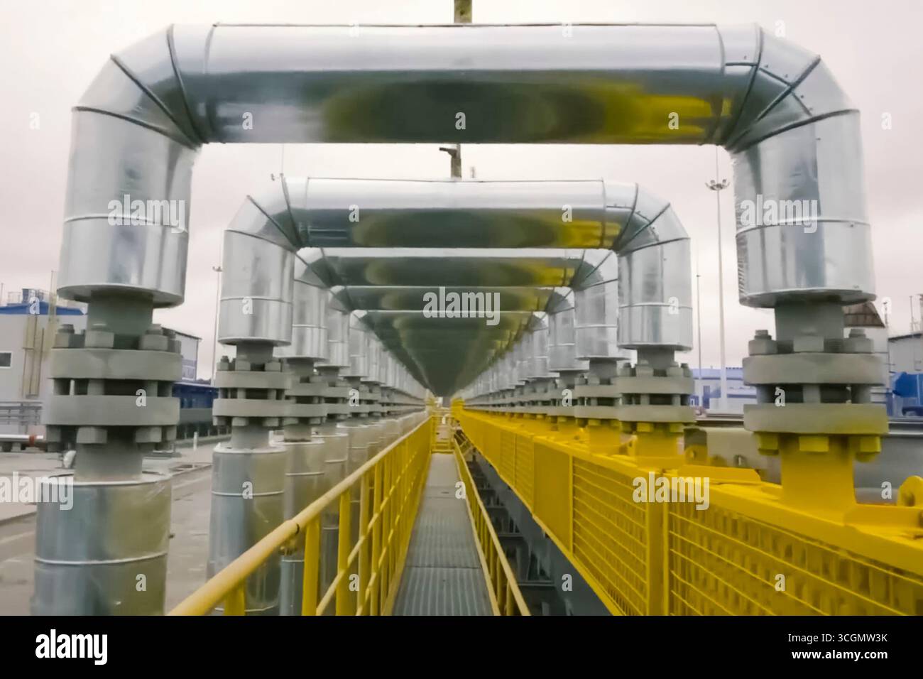 Arched form of pipes above the inspection platform. Pipelines and gate ...