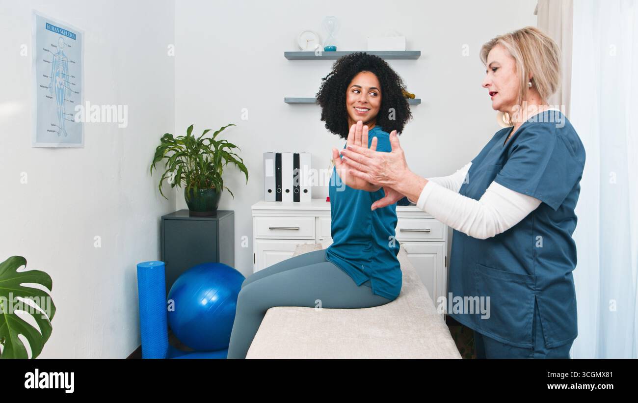 Senior Physiotherapist Conducts a Detailed Movement Assessment on a ...