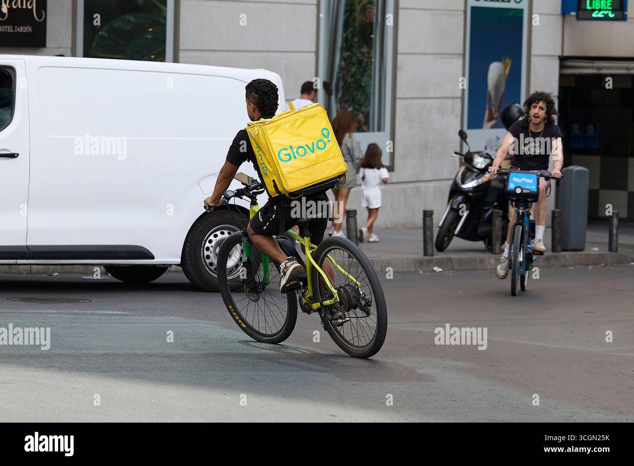 A Glovo delivery driver on a bicycle on a Madrid street, August 29 ...