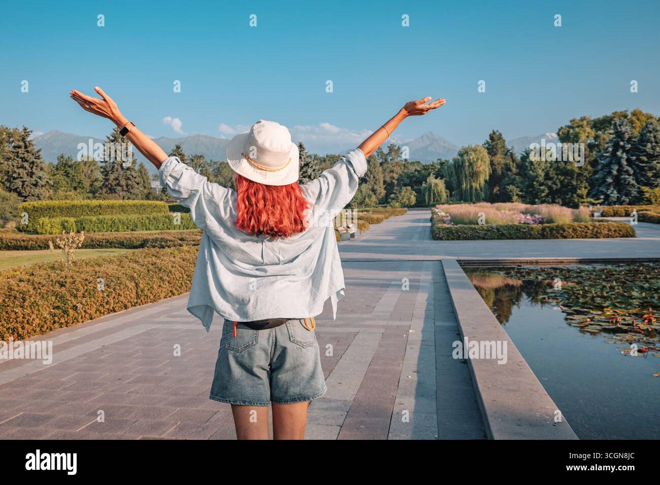 Carefree tourist with open arms enjoying the beauty of the Botanical ...