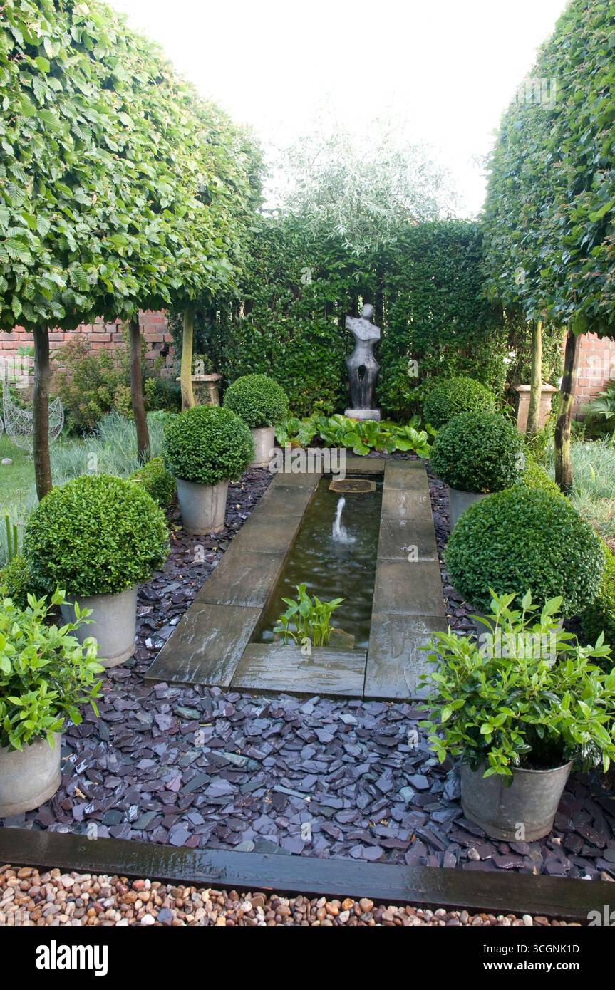 Intricate garden design showcases a calming water feature surrounded by ...