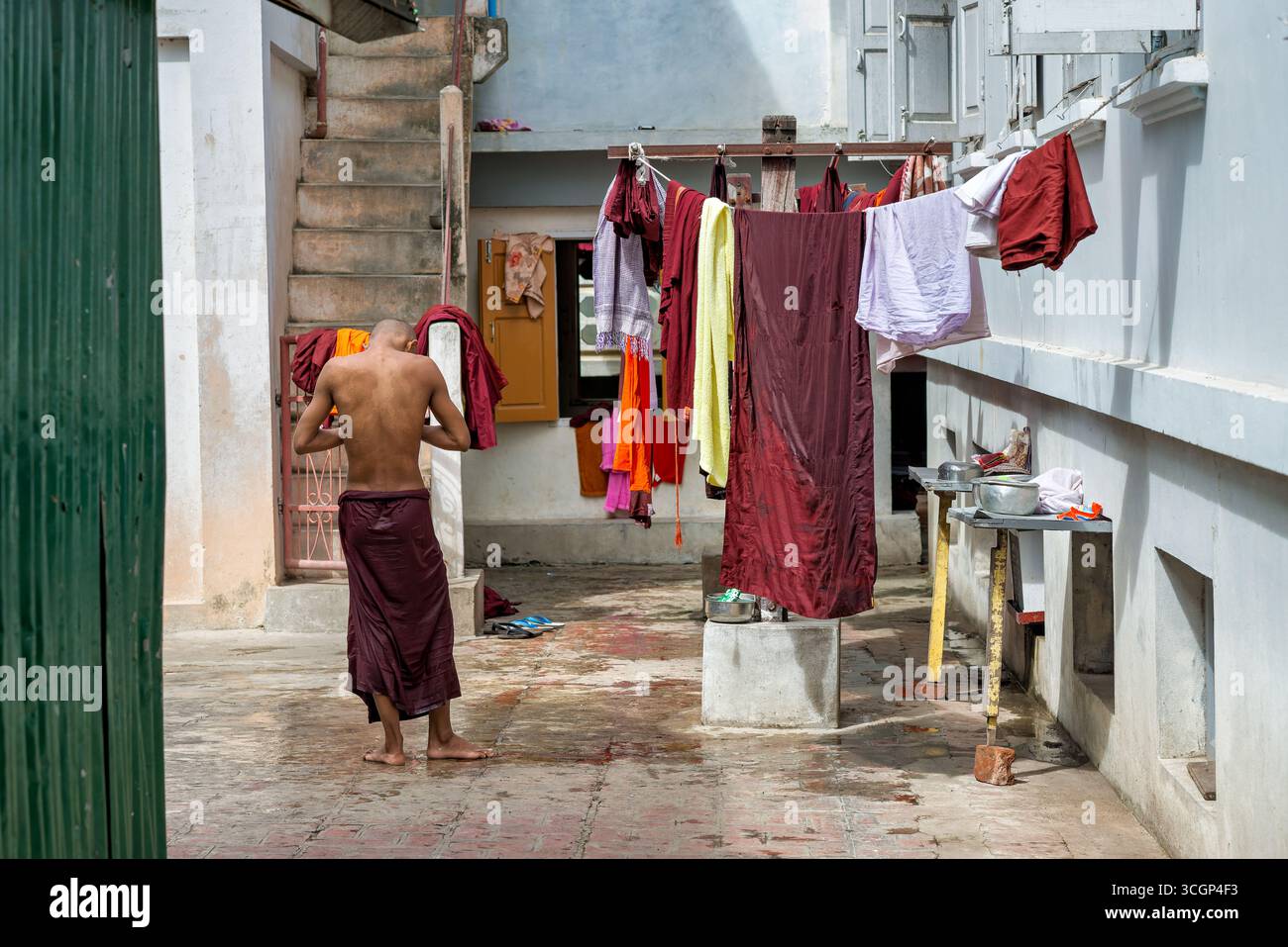 Monk washing clothes hi-res stock photography and images - Alamy