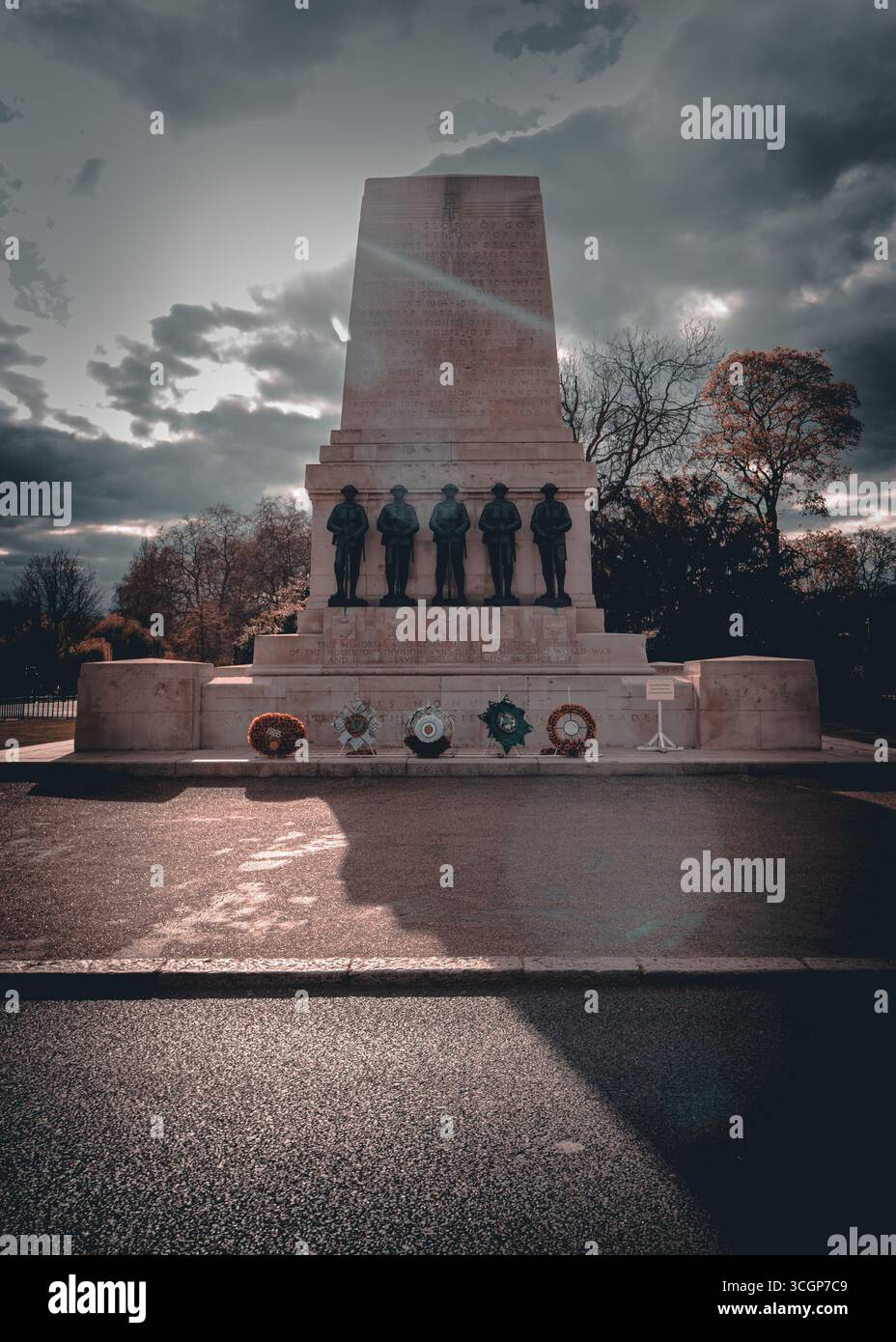 War memorial with soldier statues and wreaths laid in remembrance ...