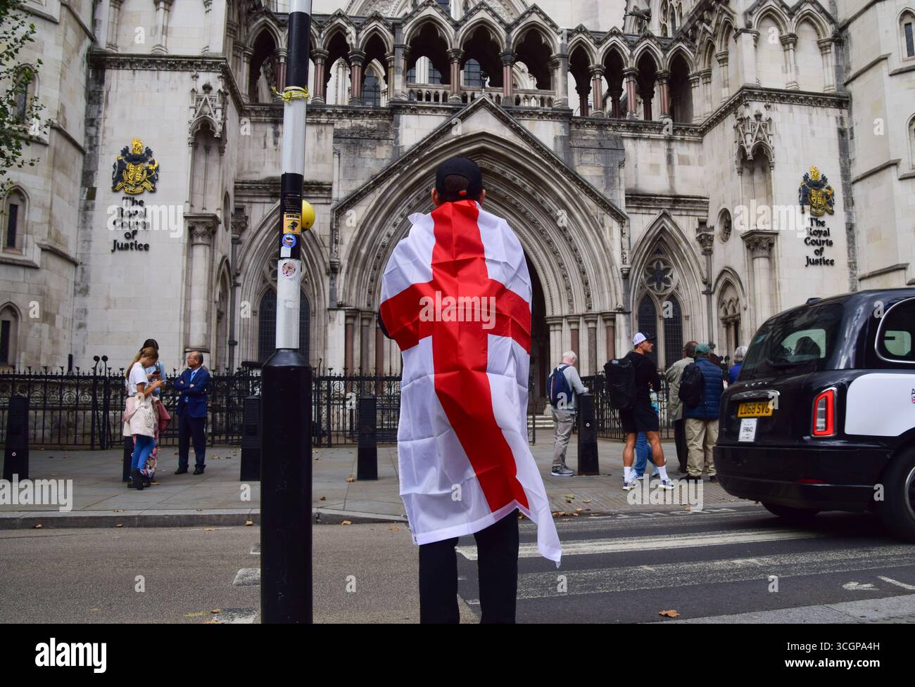 London, England, UK. 29th Aug, 2025. A man draped in an English flag ...