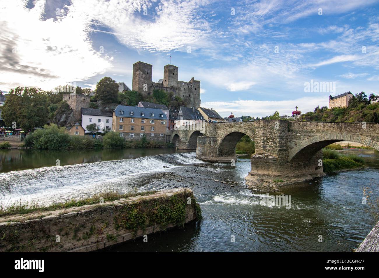 A town with a castle and a river. The historic center at night in a ...