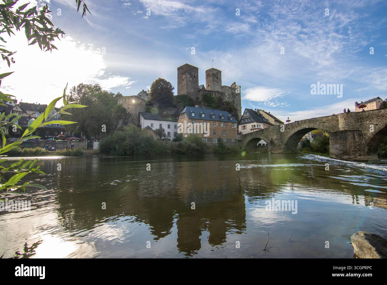 A town with a castle and a river. The historic center at night in a ...