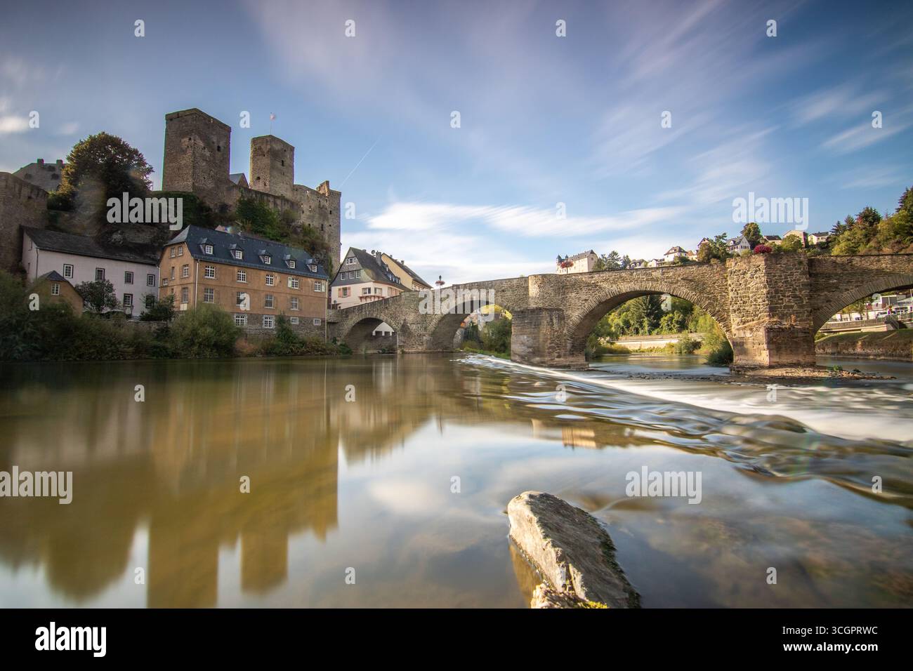 A town with a castle and a river. The historic center at night in a ...