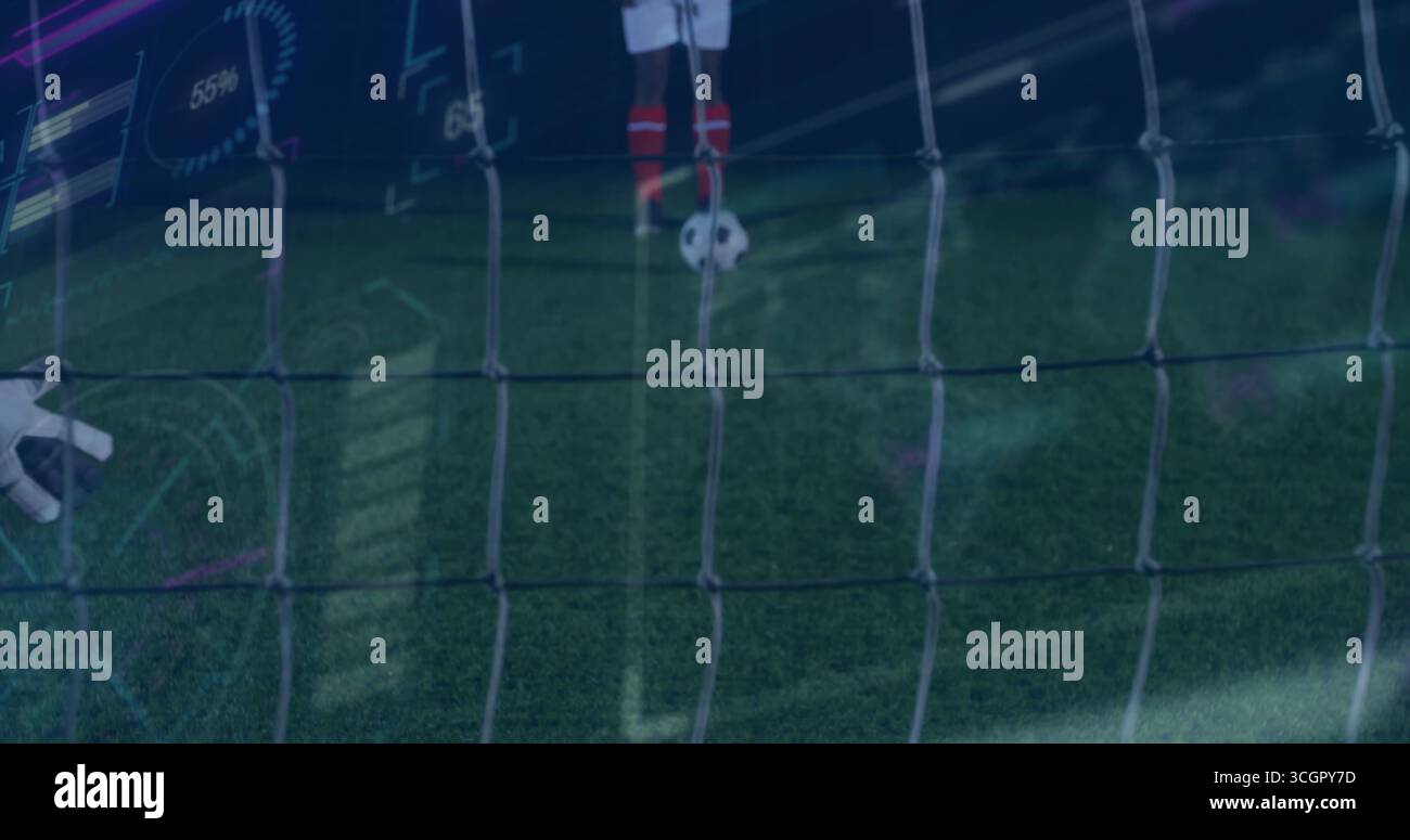 Balancing soccer player placing foot on ball on stadium turf by goal ...