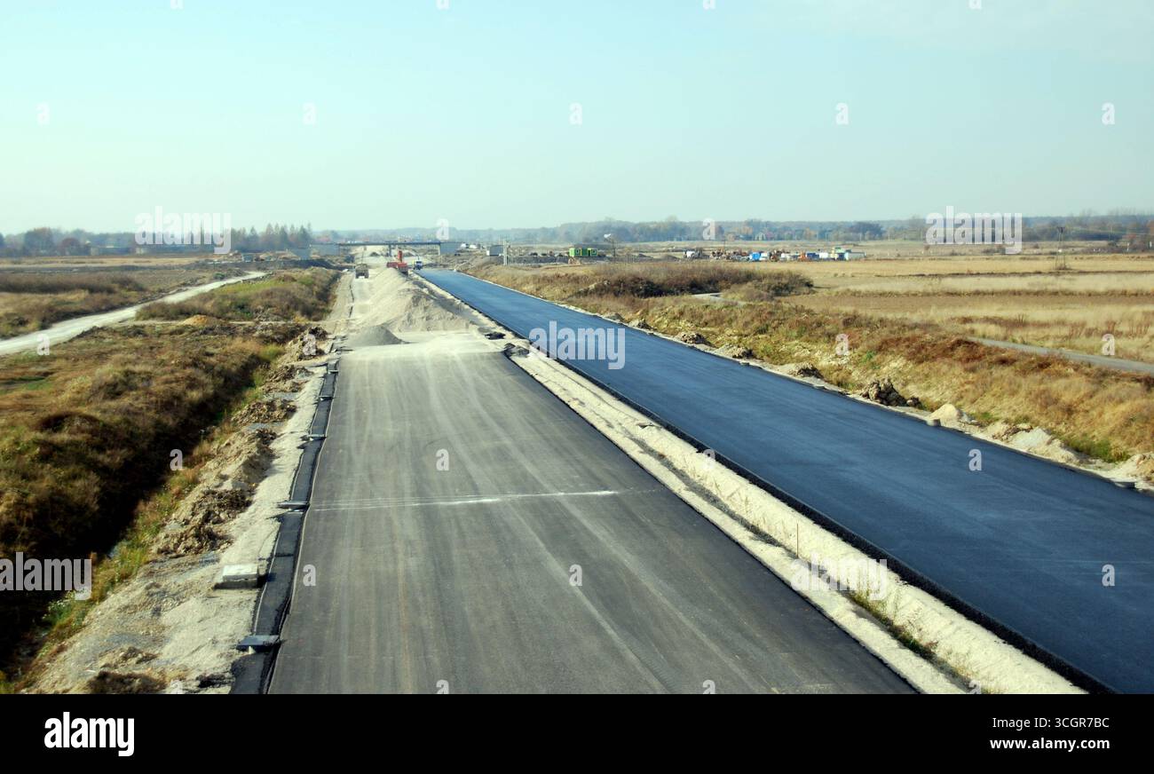 Highway A4 construction – heavy machinery and asphalt base Stock Photo ...