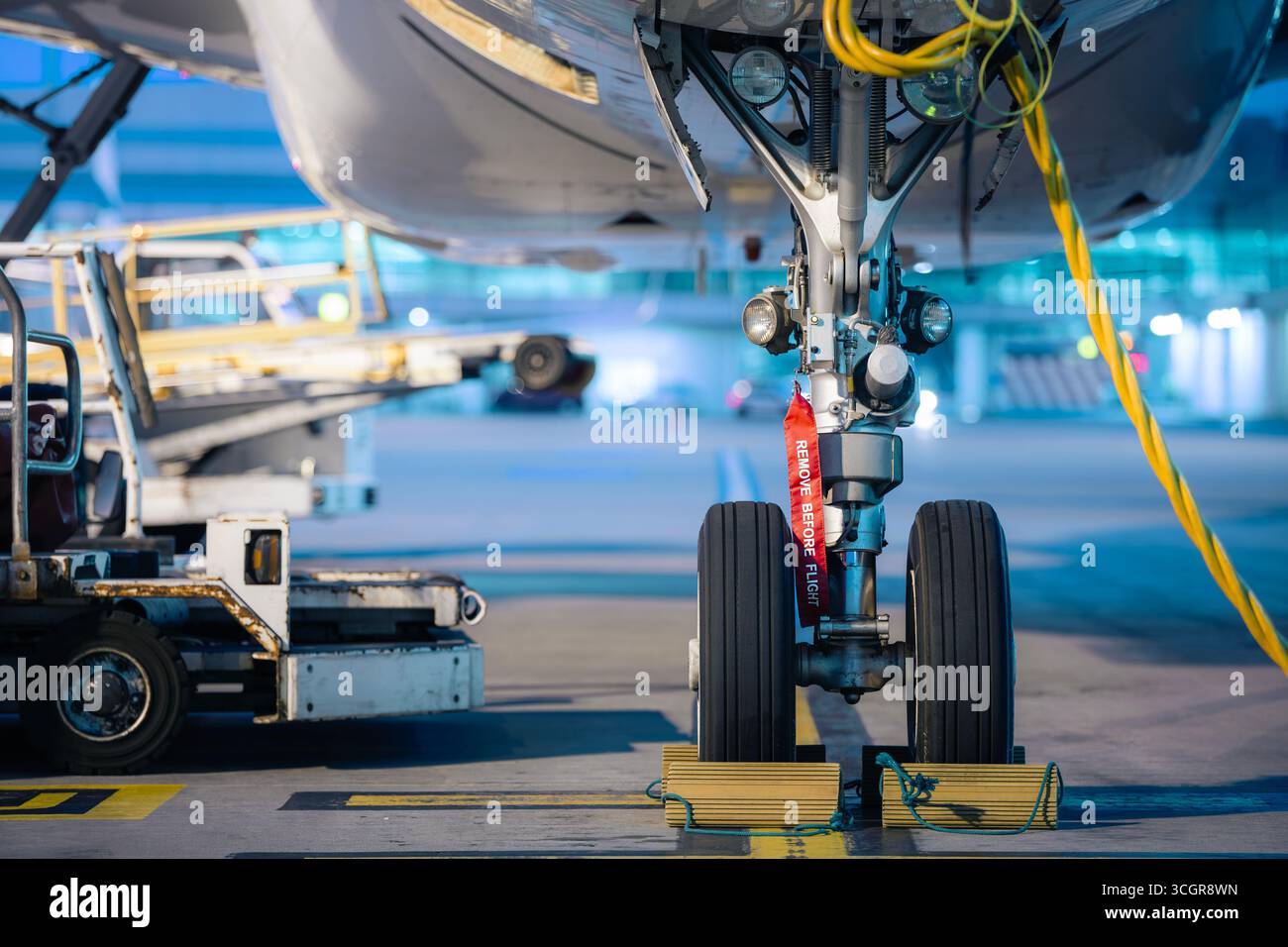 Aircraft nose wheel with red flag Remove Before Flight. Selective focus ...