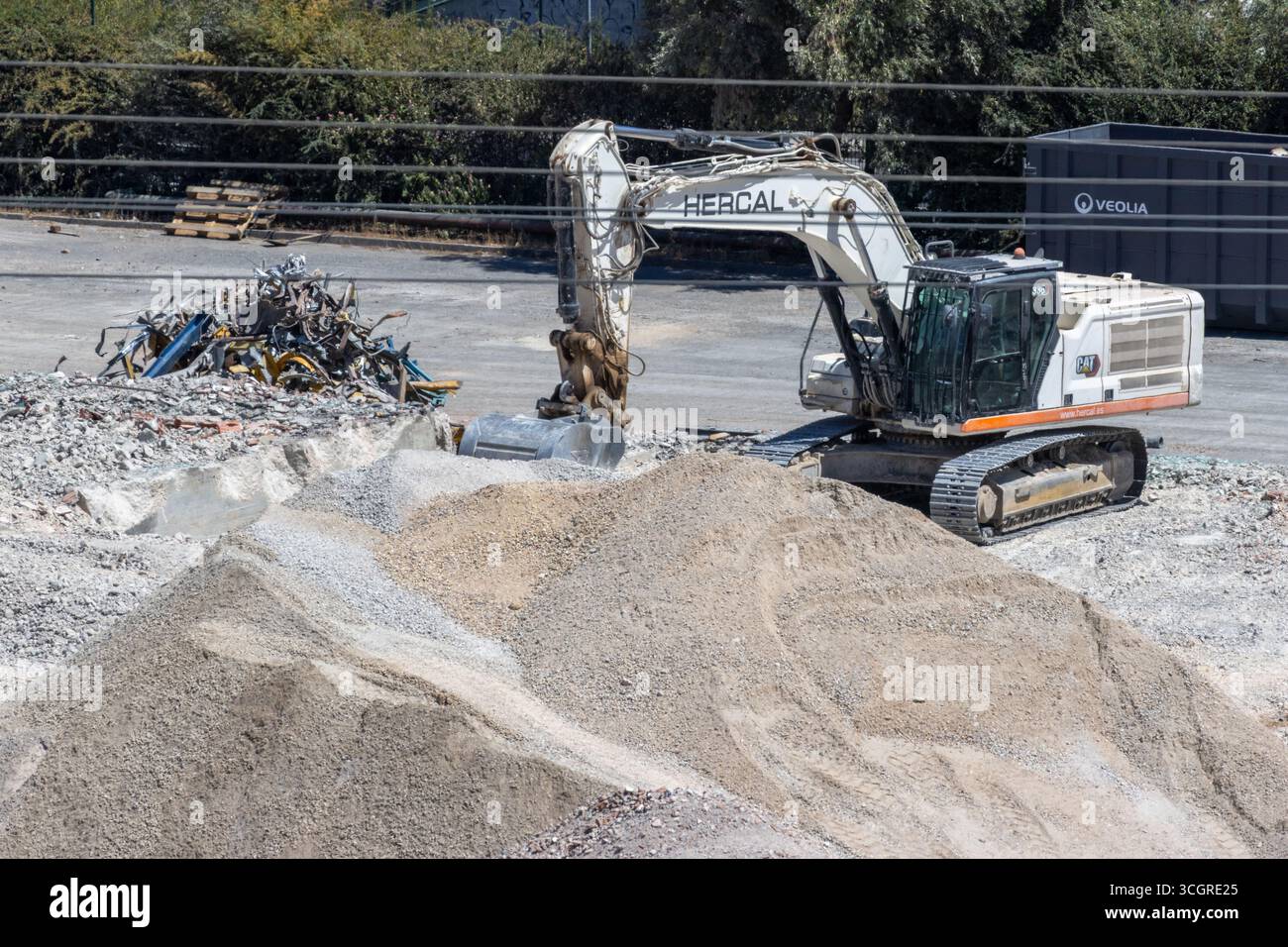 Excavator loading debris into dump truck at construction site ...