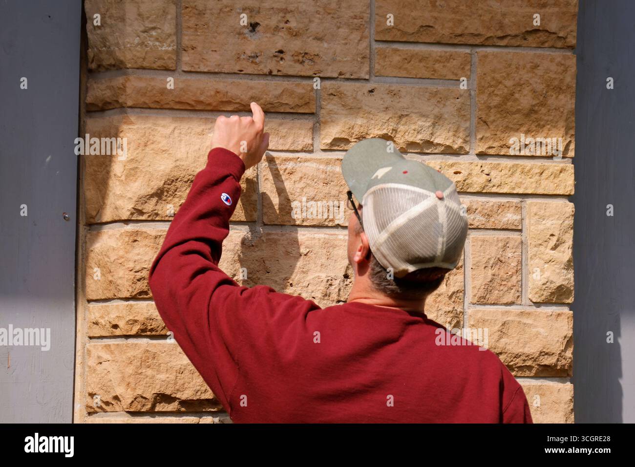A man looks at the holes in the walls outside Annunciation Catholic ...