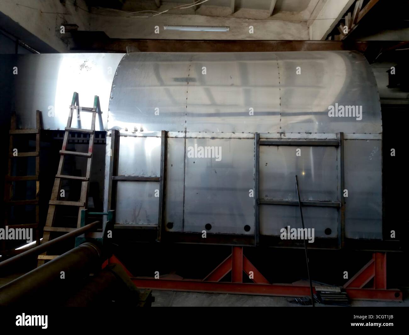 In a manufacturing facility, workers focus on creating aluminum unit ...