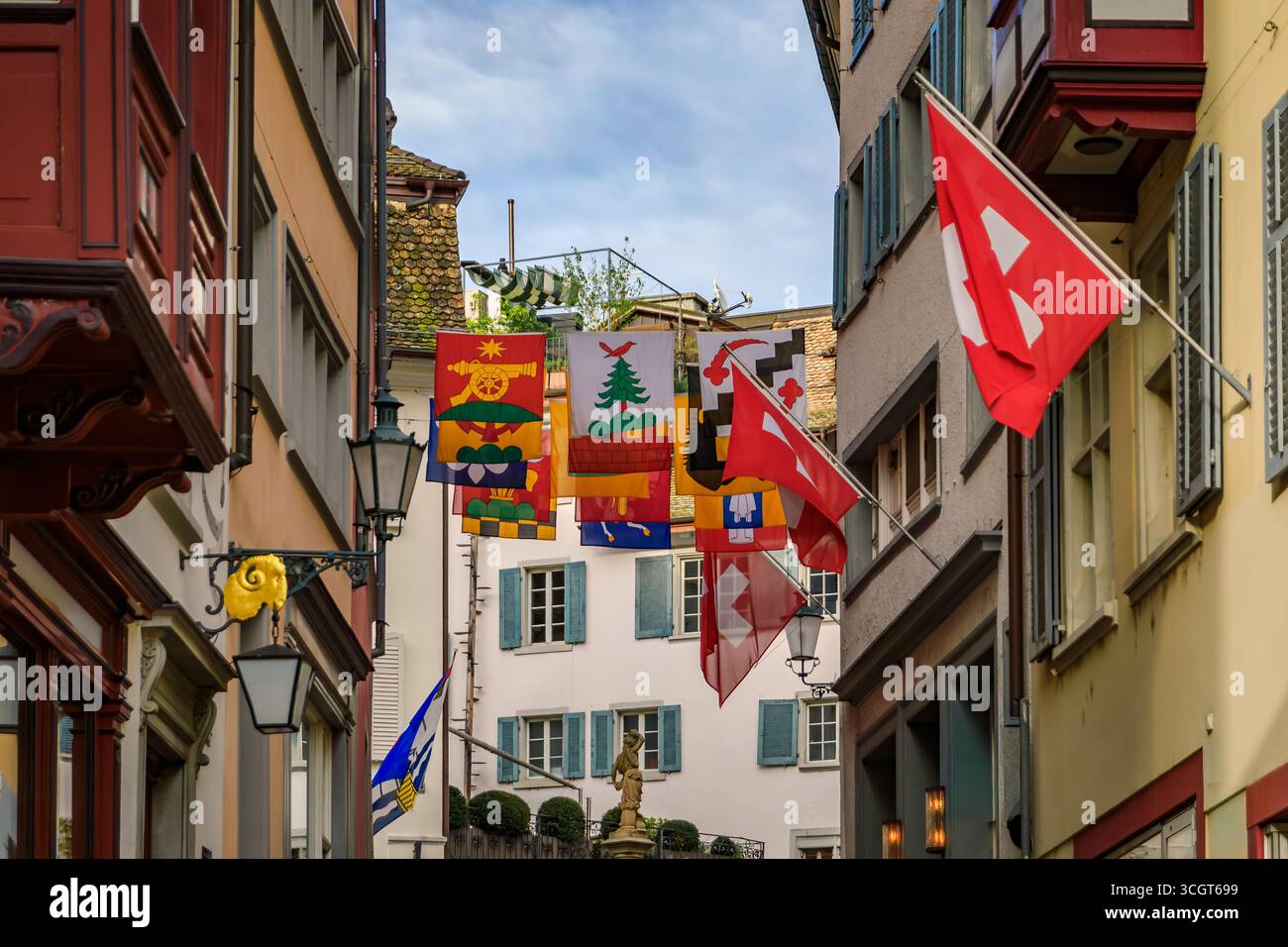 Swiss flags hang from the historic facades of traditional buildings in ...
